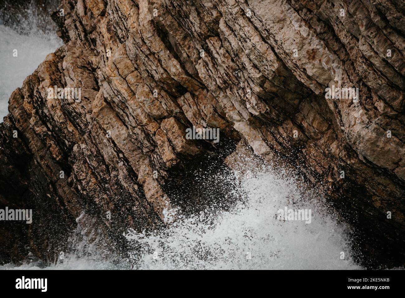 A view of water splashing on a natural rocky formation creates a ...