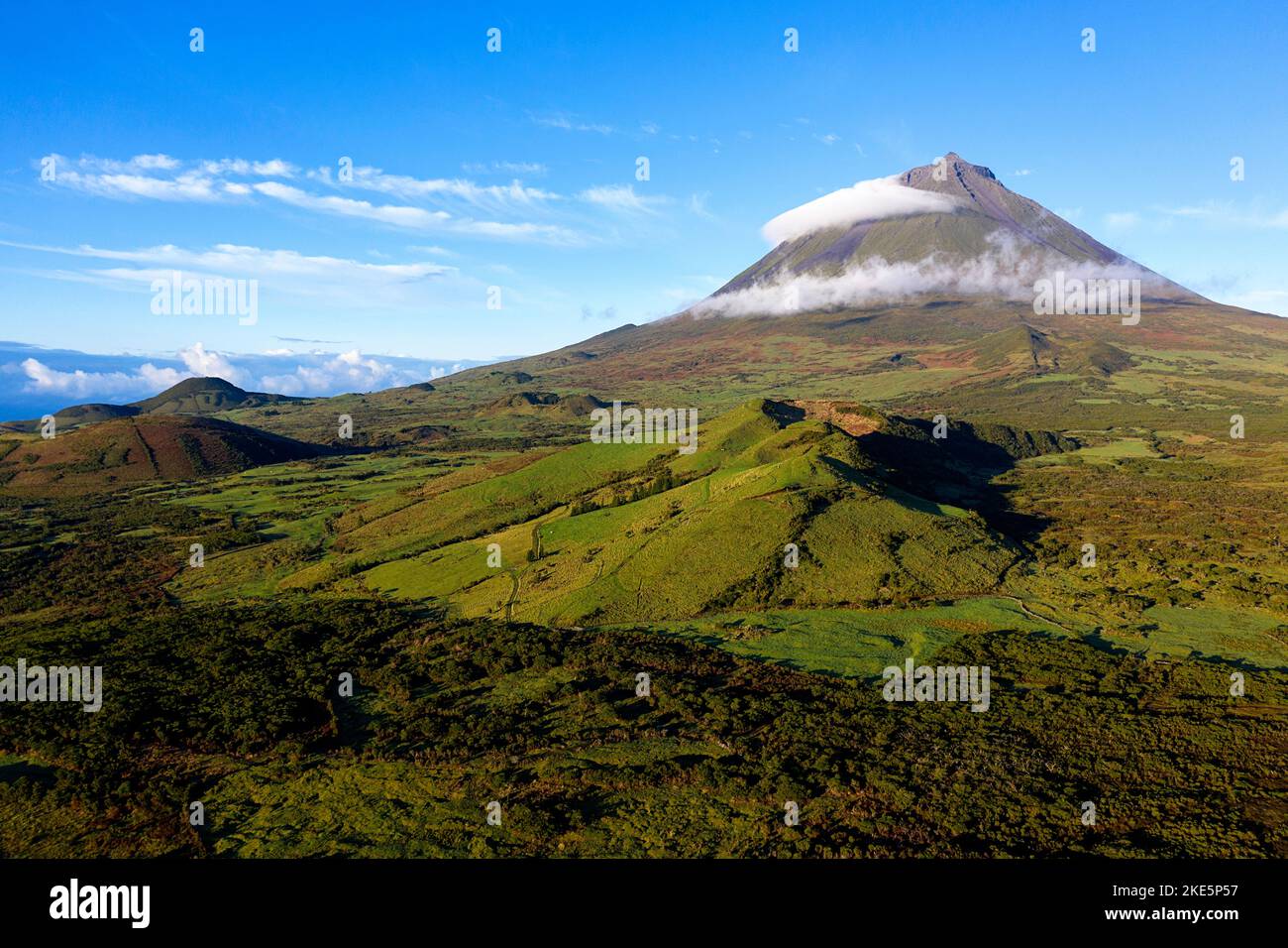 Aerial view of a Ponta da Pico volcano partly covered in cloud with ...