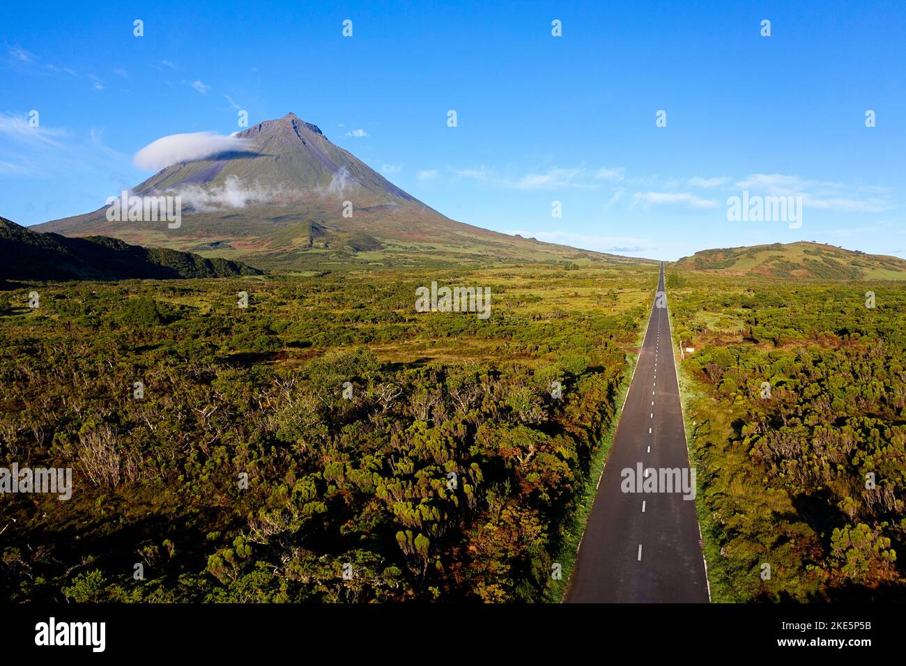 Aerial view of a road passing Ponta da Pico partly covered in cloud ...
