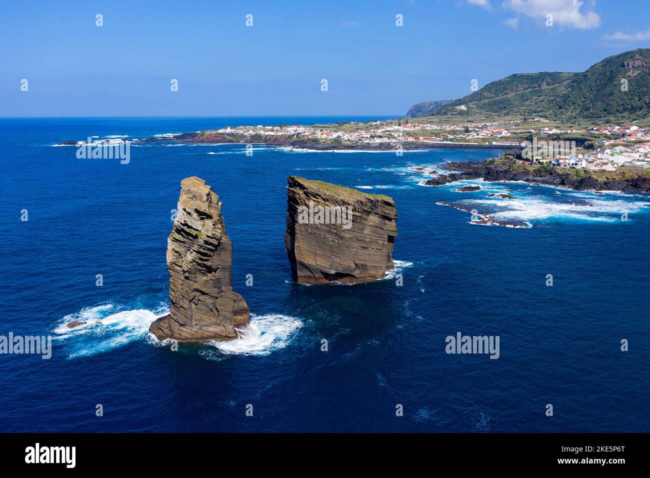 Aerial view of Two volcanic rocks in the sea near the beach and the ...