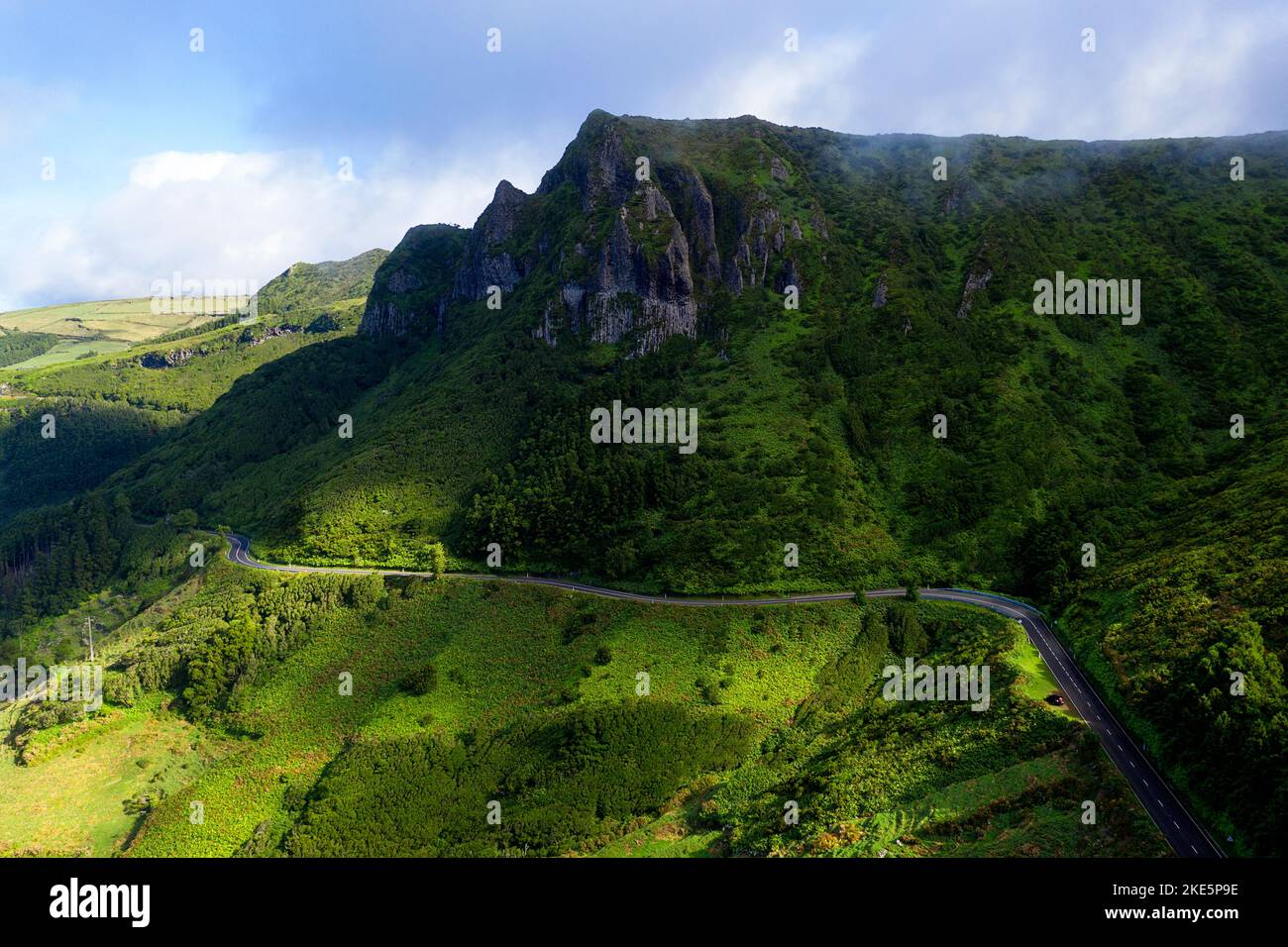 Aerial view of a scenic road near Rocha dos Bordões cliffs on western ...