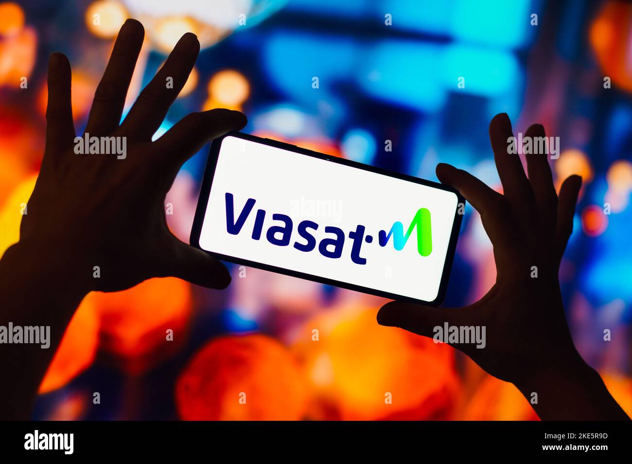 In this photo illustration, the ViaSat Inc. logo is displayed on a ...
