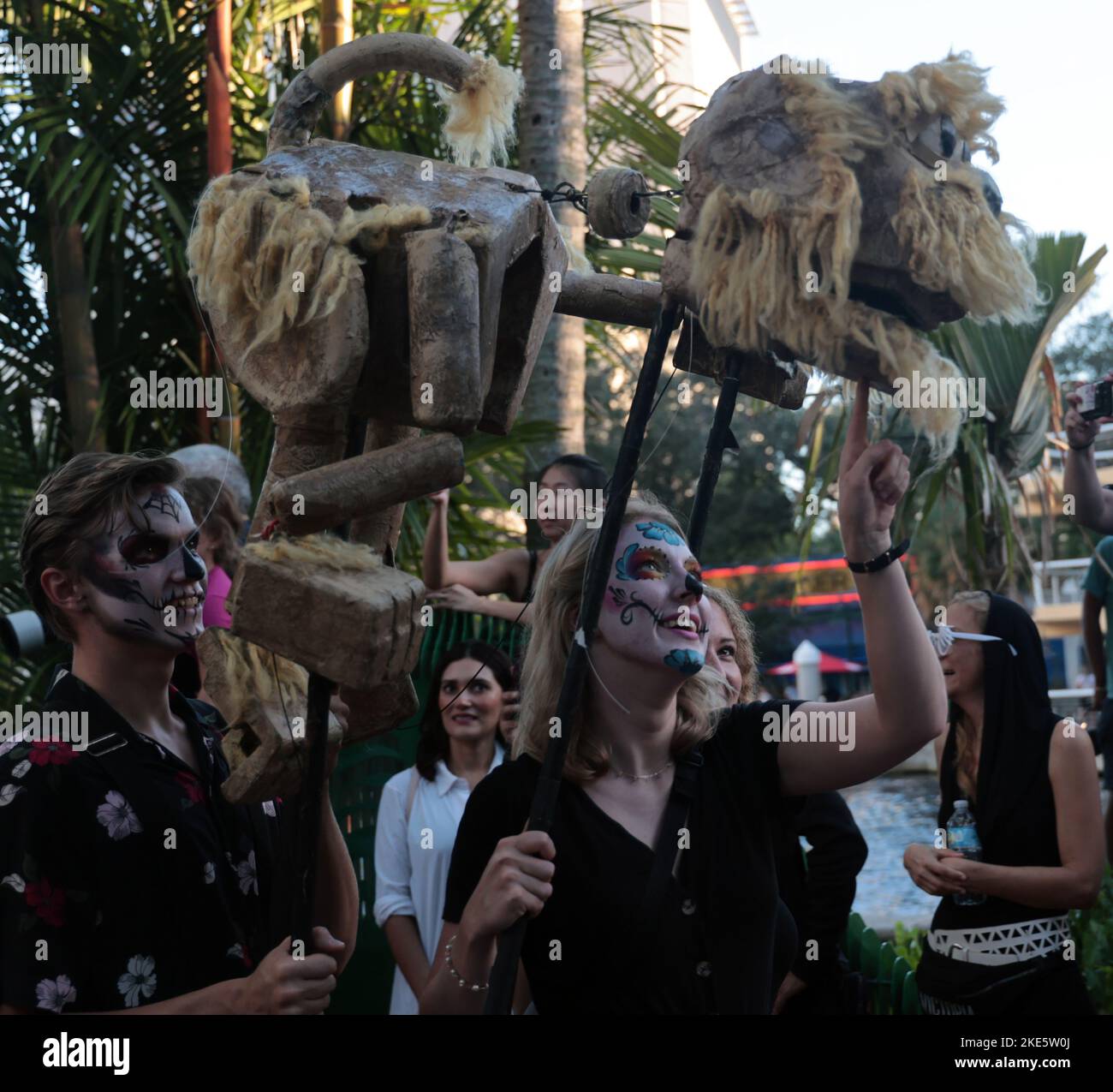 A closeup of women with painted faces and a statue in hands during the ...