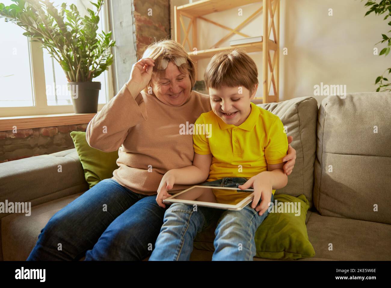 Happy grandmother and grandson spending time together at home. Concept ...
