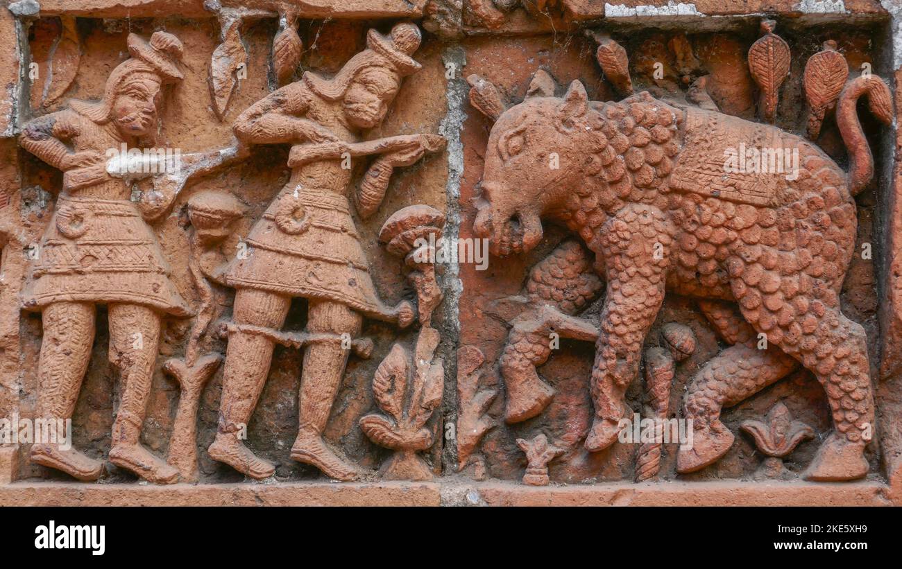 Detail of hunters and mythological creature terracotta carving at ...