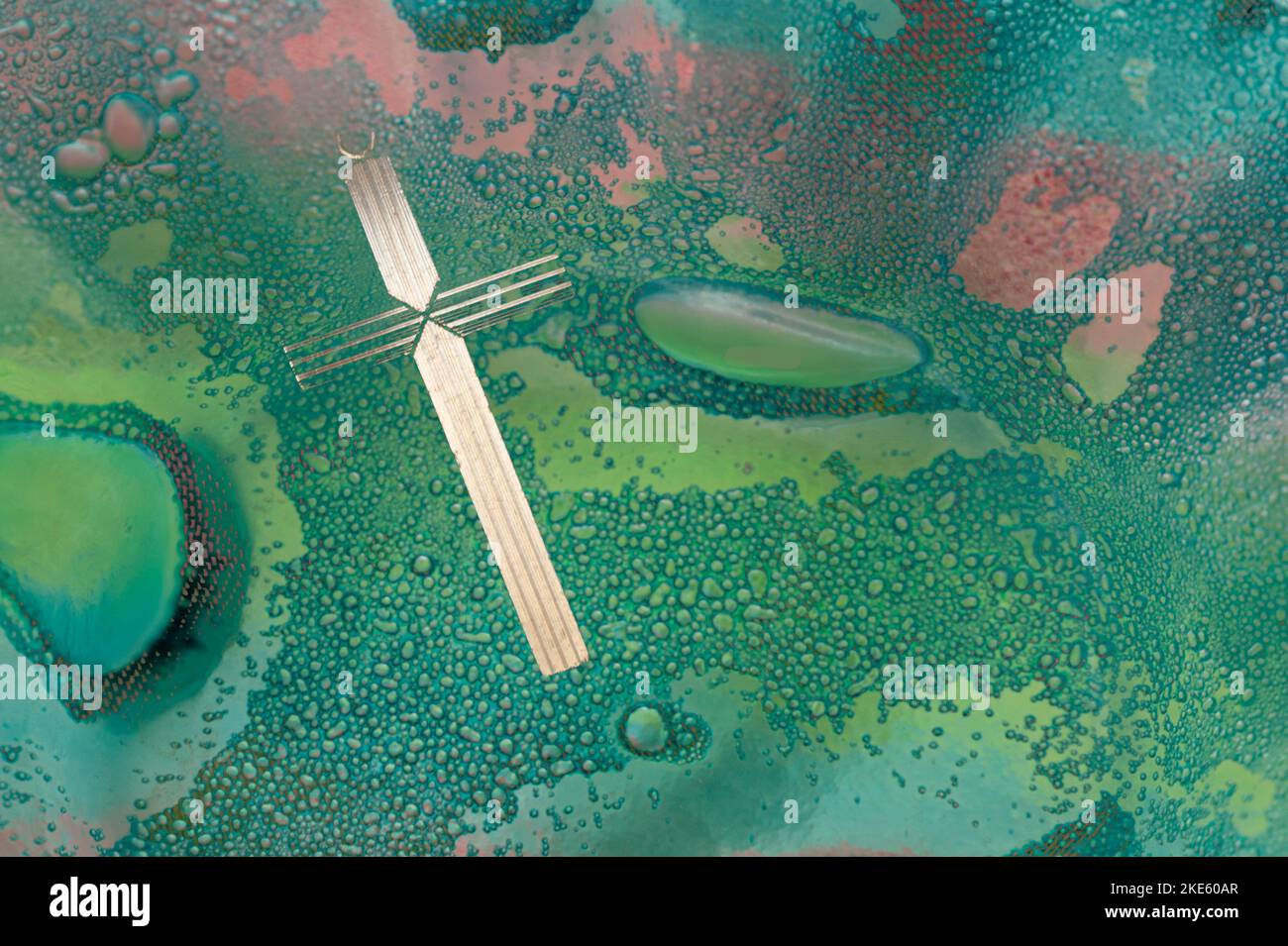 Composite backlit photo of gold Christian cross on abstract pastel ...