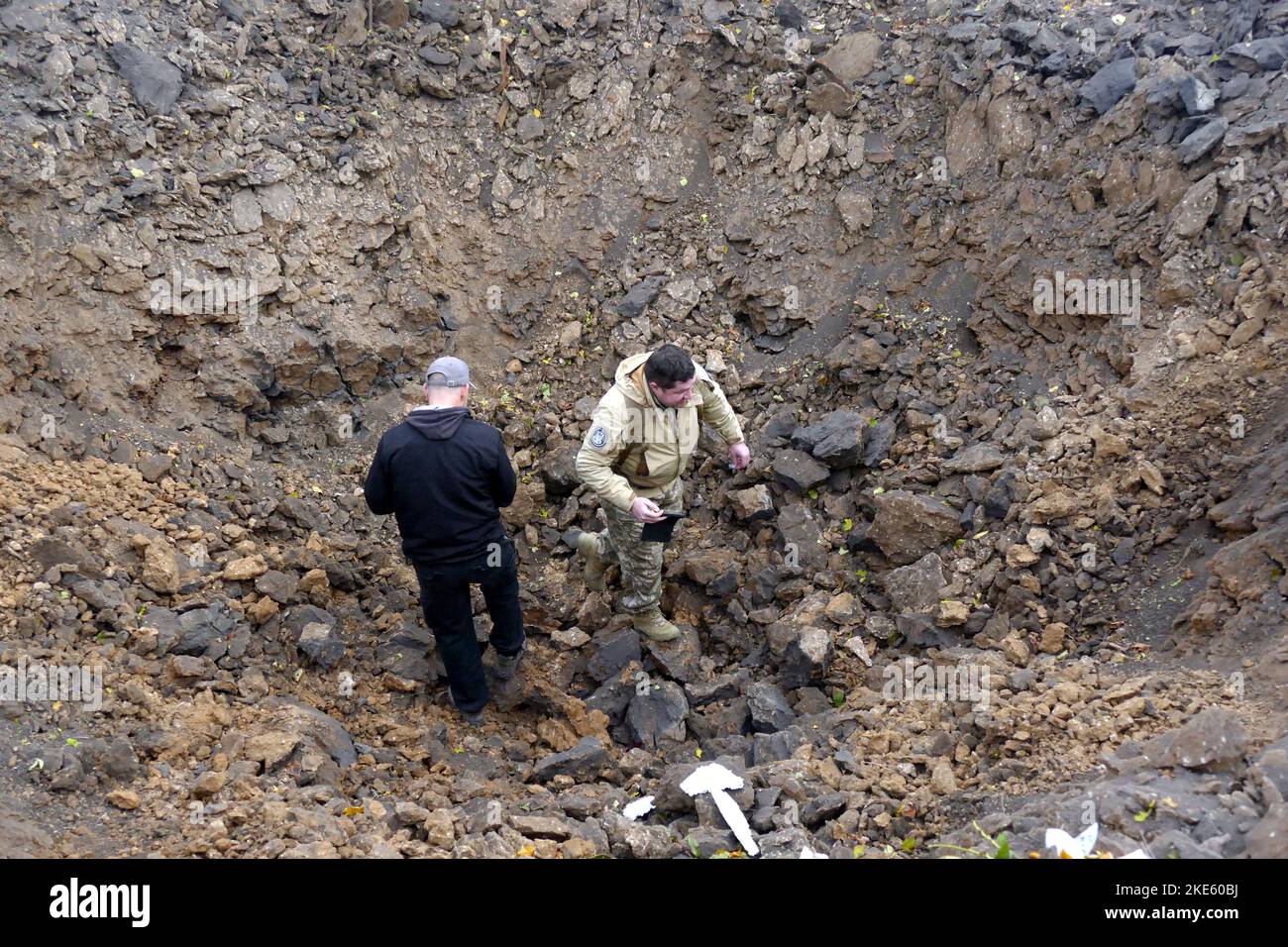 MYKOLAYIV, UKRAINE - NOVEMBER 09, 2022 - Men are seen in a shell crater ...