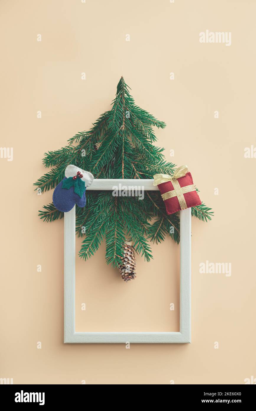 DIY Christmas tree with Christmas decorations in frame. Pastel beige ...