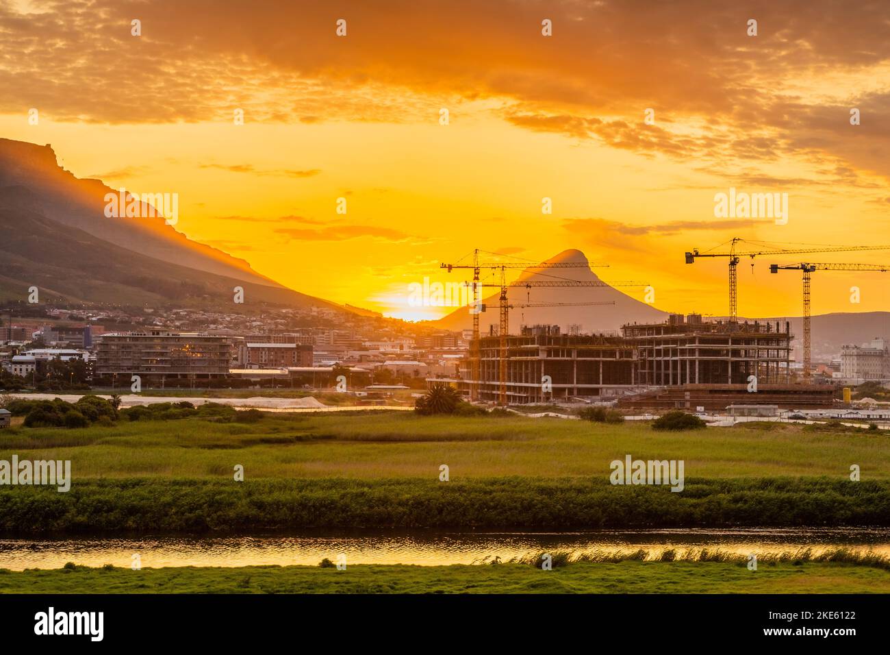 Construction cranes on building site at sunset in Cape Town, South ...