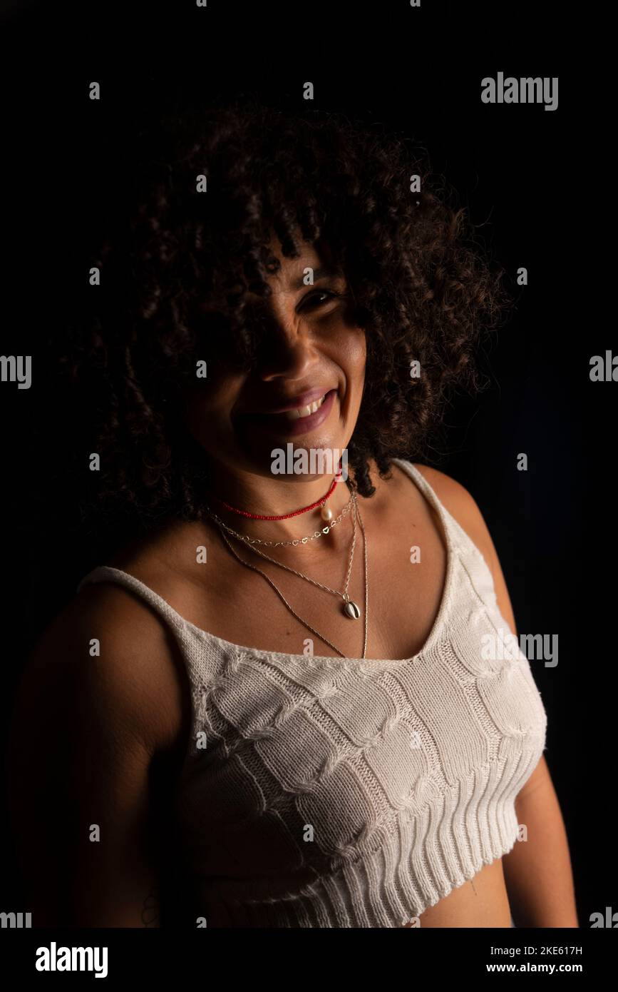Vertical portrait of a happy woman against black background. Joy ...
