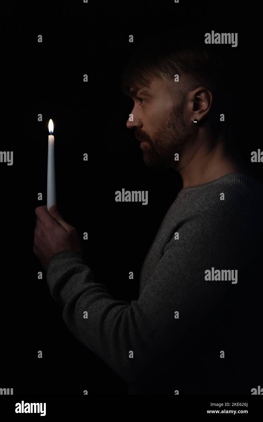 Man holding lit candle outdoors hi-res stock photography and images - Alamy