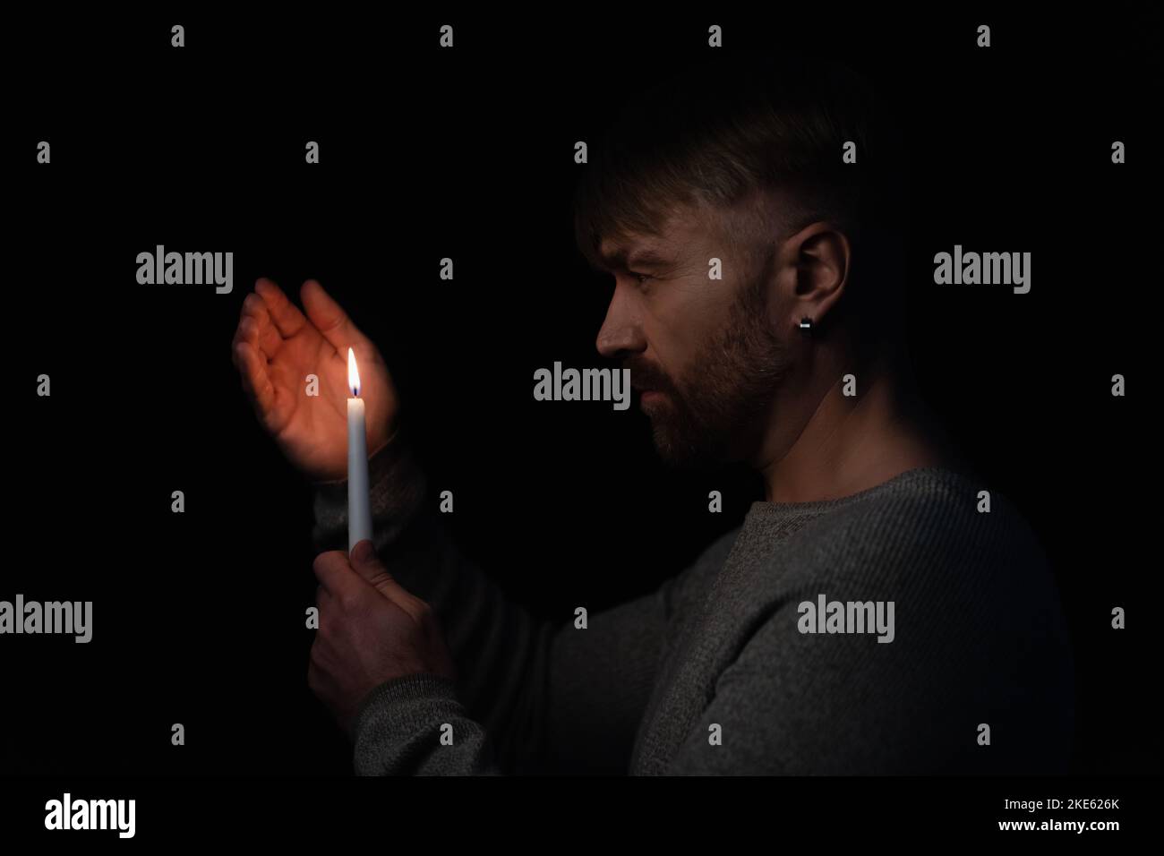 Man holding lit candle outdoors hi-res stock photography and images - Alamy
