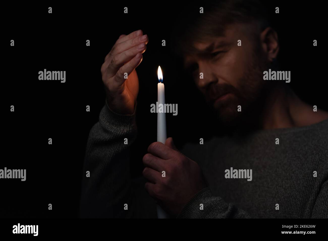 Man lit candle light in hi-res stock photography and images - Alamy