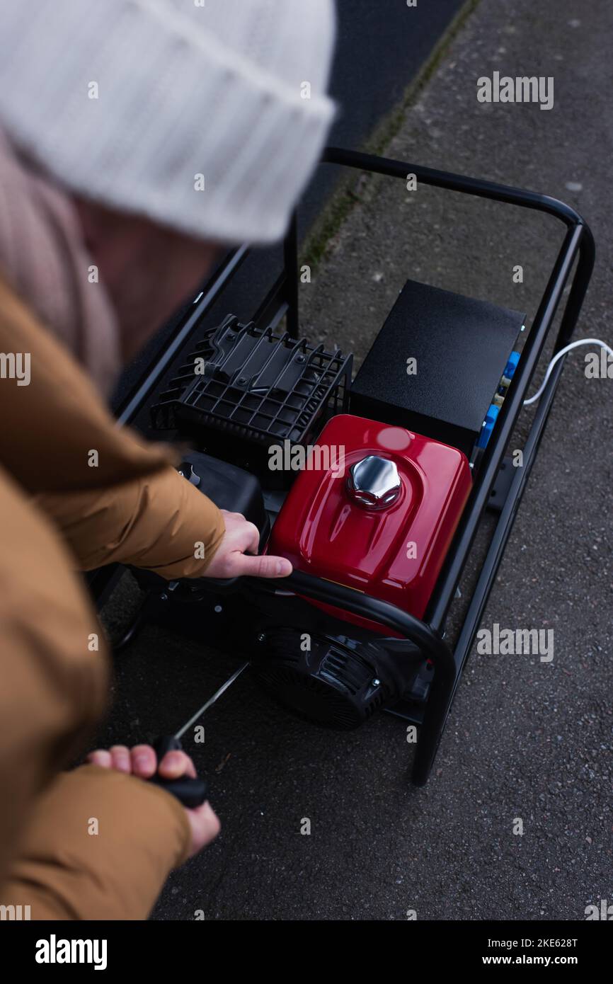 high angle view of blurred man starting power generator because of ...