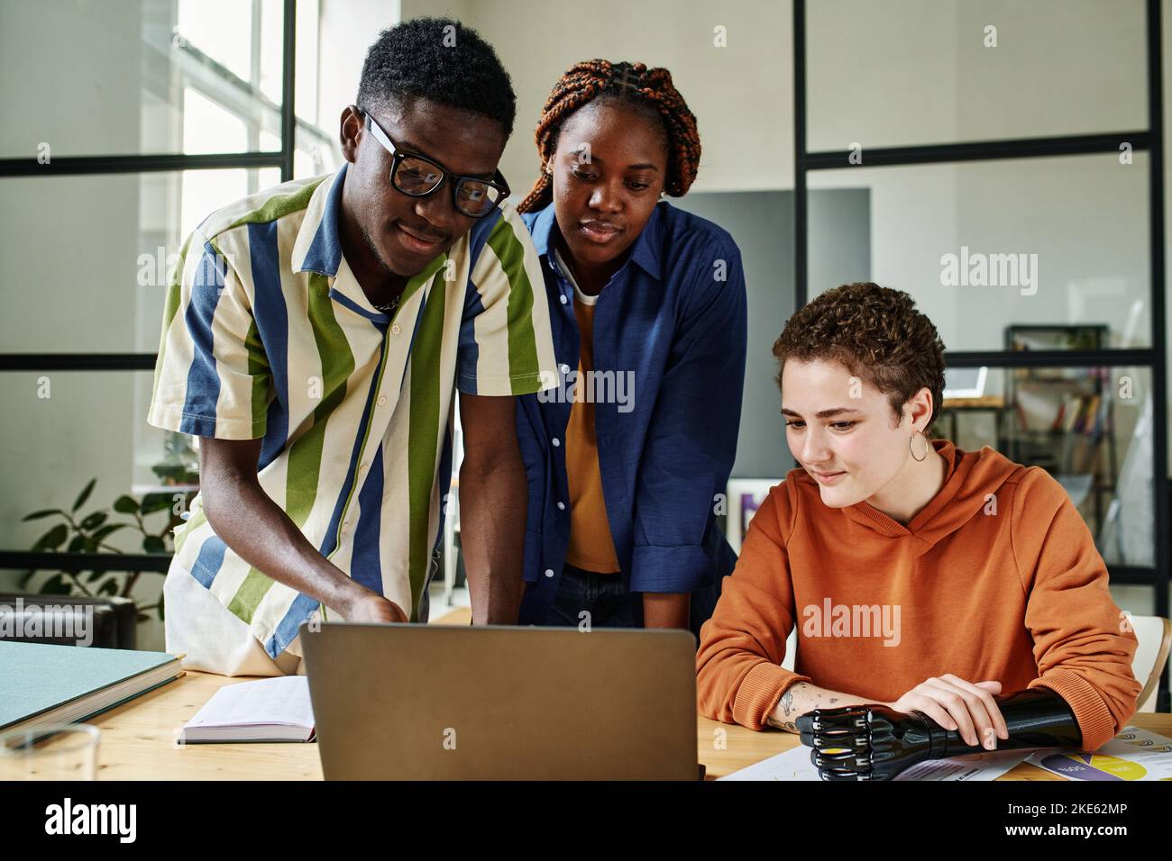 Young African American employee pointing at laptop screen while ...
