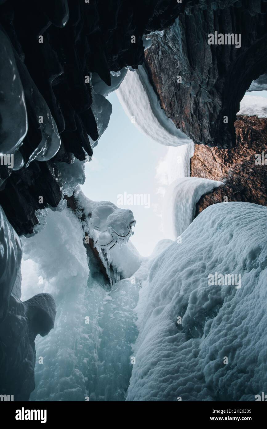 A vertical low angle shot of snowy rocks in the hills Stock Photo - Alamy