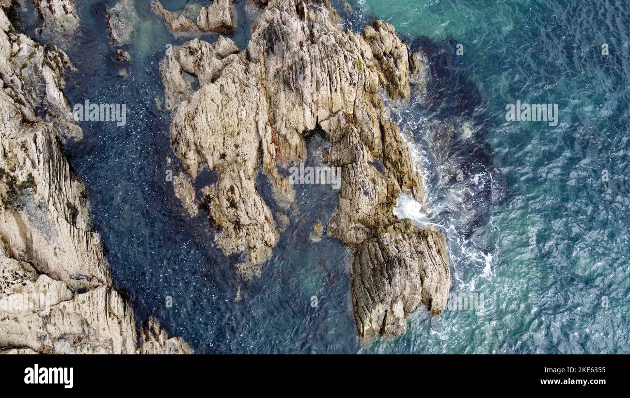 A lot of boulders in the sea water. Coastal cliffs of the North ...