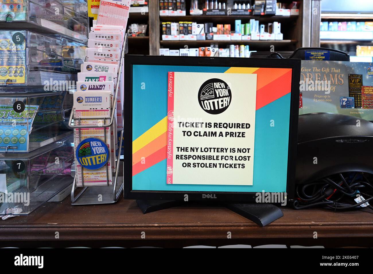 A variety of different lottery tickets stacked on the counter of a ...