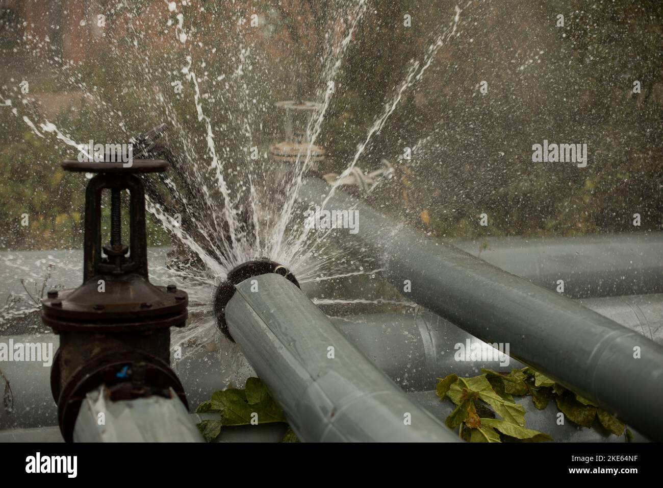 Valve on tube. Torn pipe valve. Boiling water pours from pipeline Stock ...