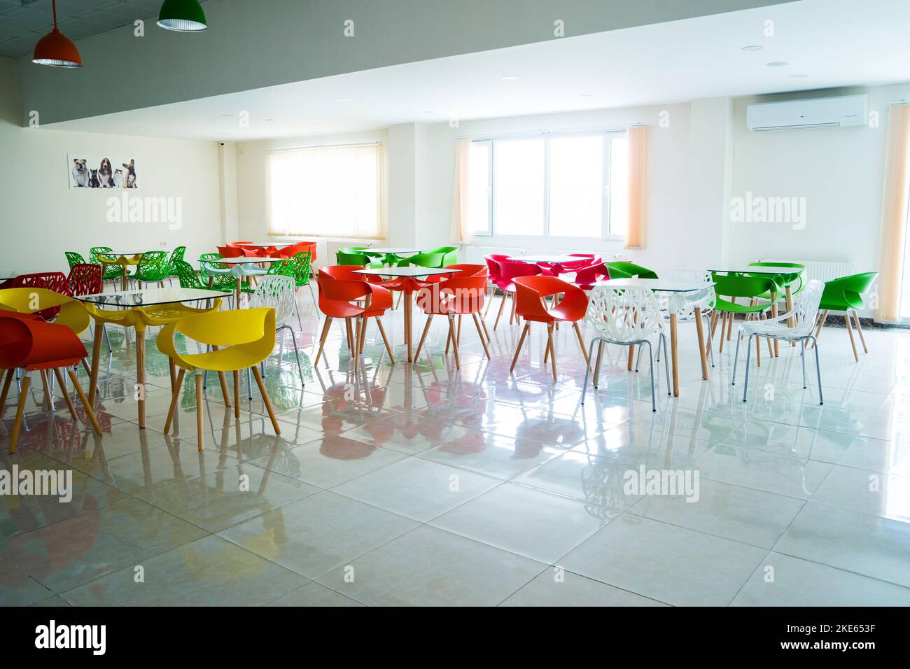 red, yellow, green plastic tables and chairs in the cafe, in the dining ...