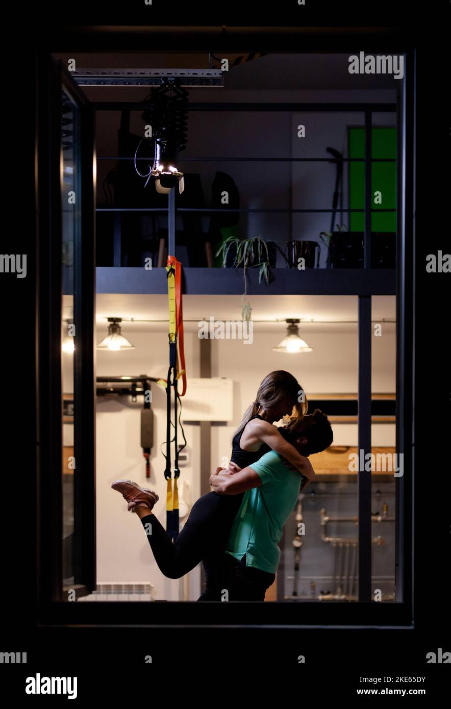 Couple in love. Boy and girl hugging in a fitness studio. View from ...