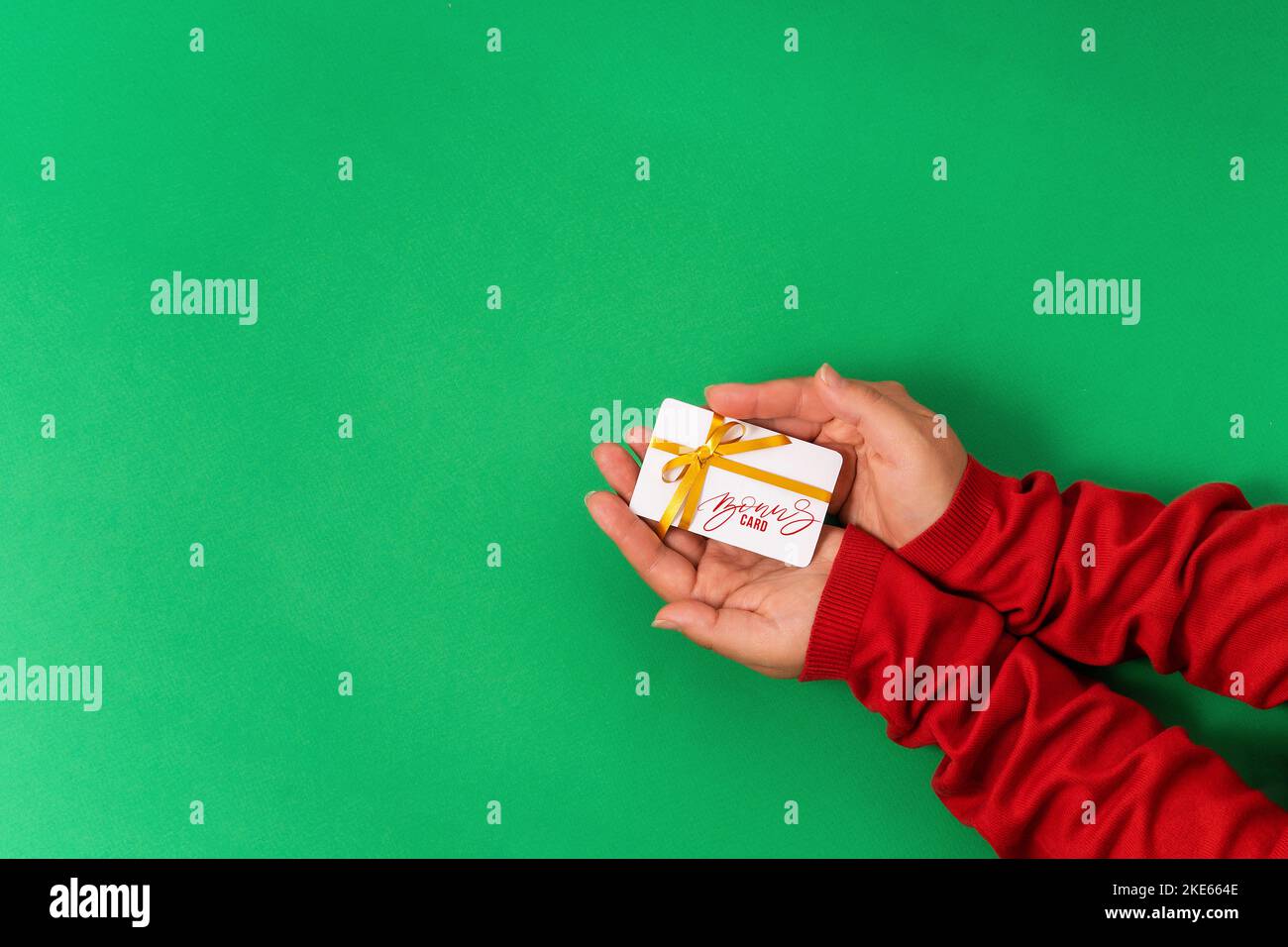 Female hand holding bonus or gift card template mockup, with gift ...