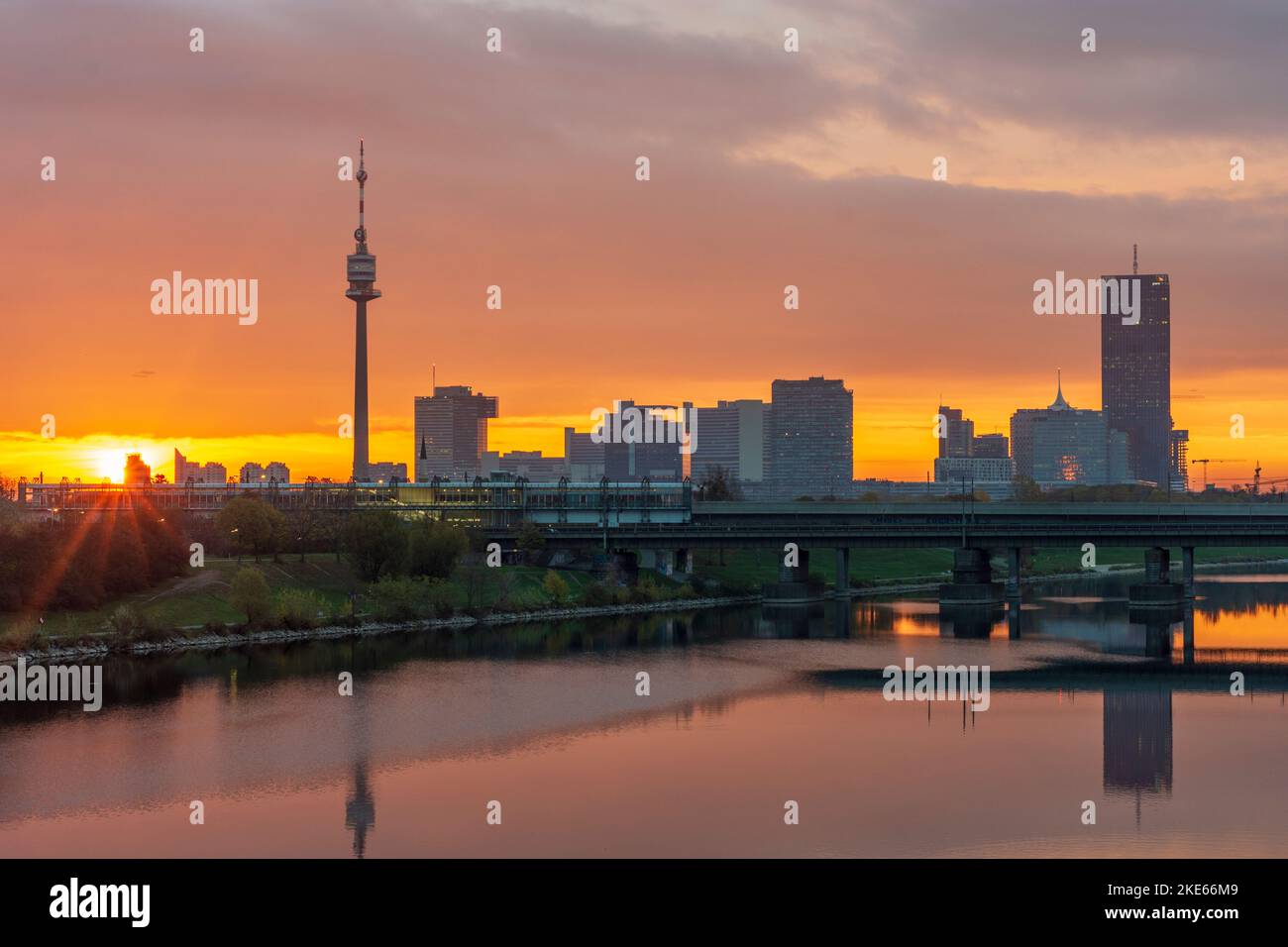 Wien, Vienna: river Neue Donau (New Danube) at sunrise, railway bridge ...