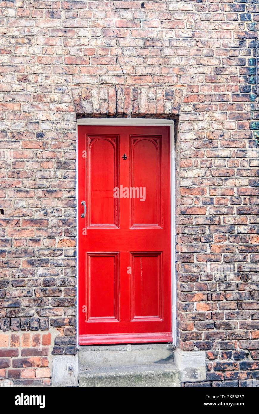 A red door in a brick wall in Durham, England Stock Photo - Alamy