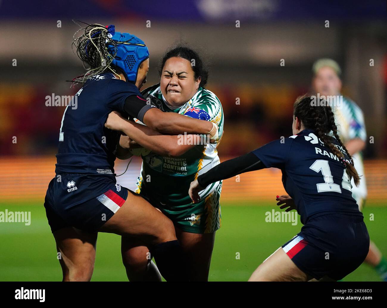 Cook Islands' Kennedy Harrison-Vahua (centre) tackled by France's Elisa ...