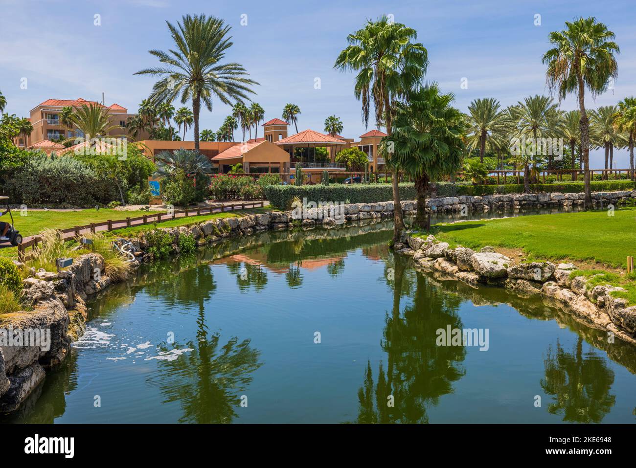 Gorgeous landscape view of hotel area with green golf fields and pond ...