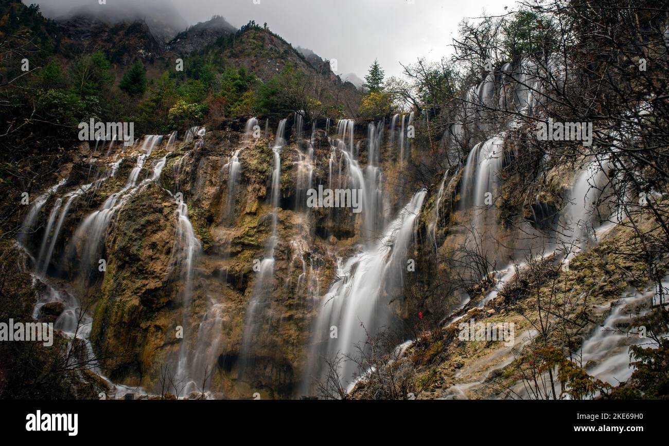 A beautiful waterfall in a forest during a cloudy day Stock Photo - Alamy