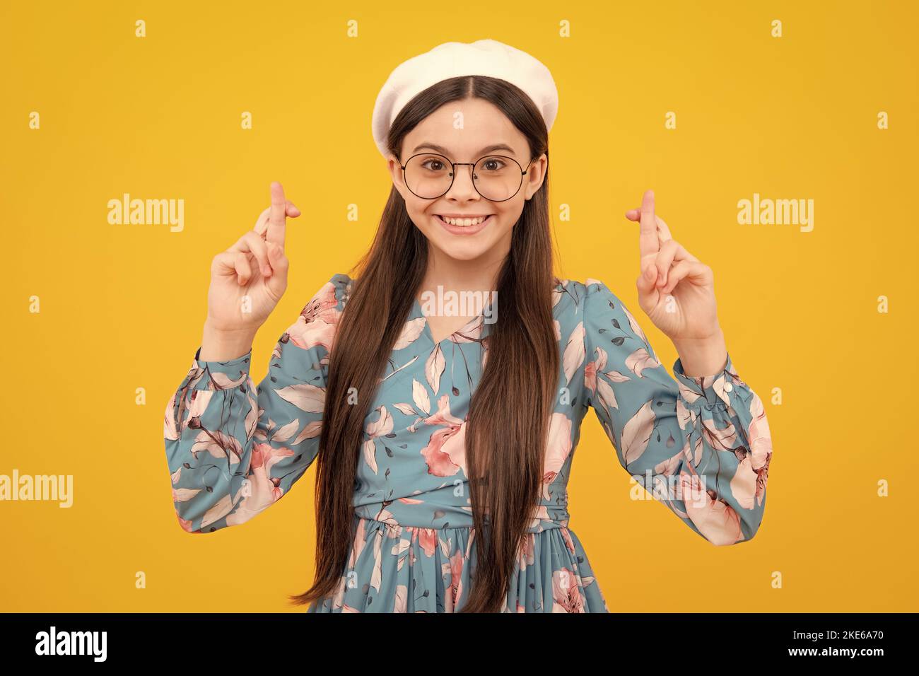 Teenager child holding fingers crossed for good luck. Girl prays and ...