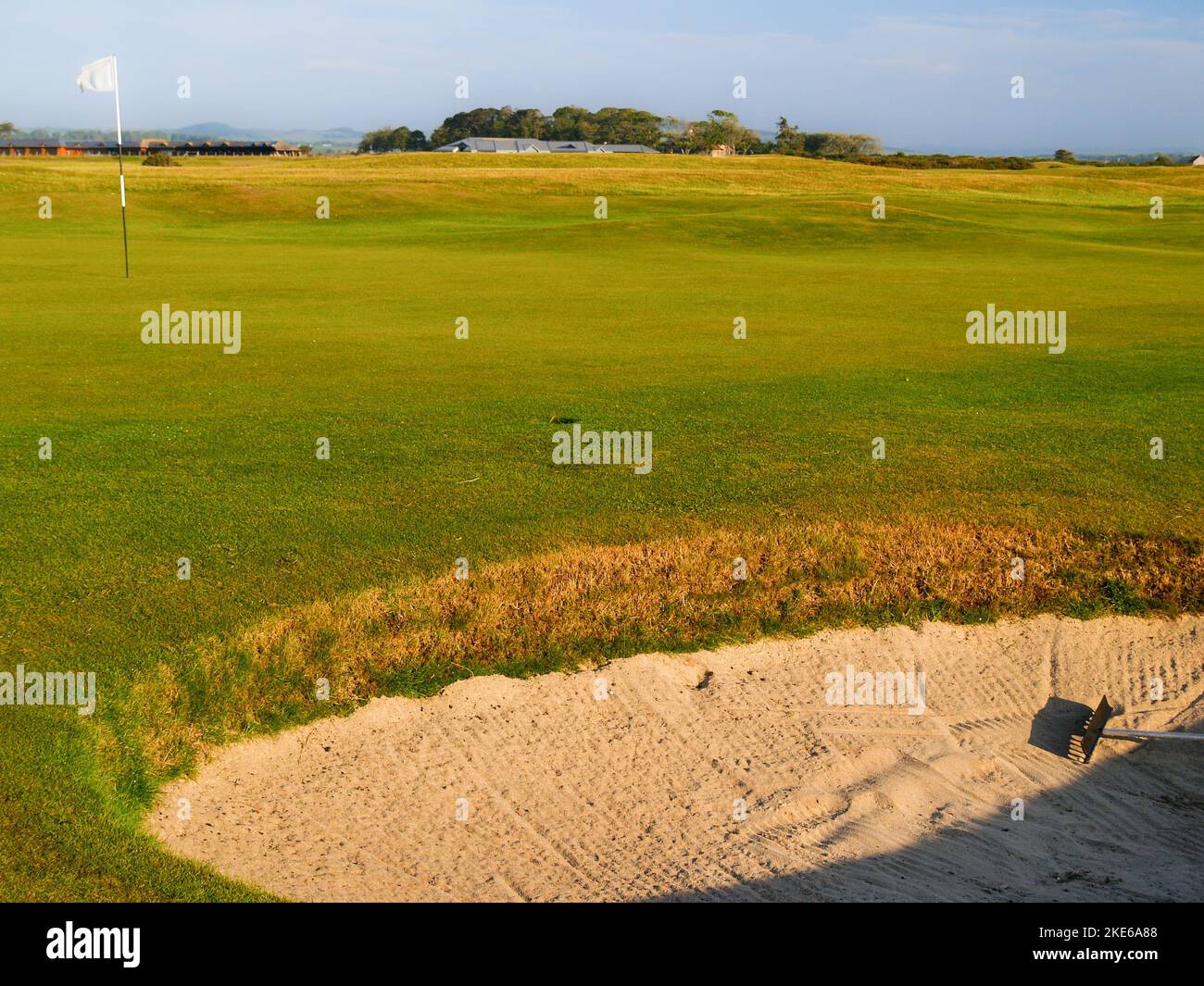 Sand bunker surrounded by short green grass on golf course Stock Photo ...