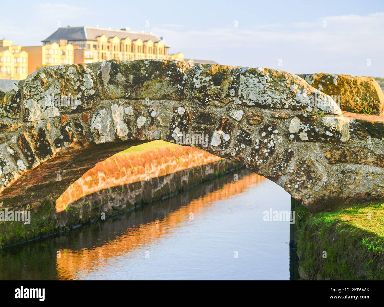 Small picturesque stone arch bridge over creek Stock Photo - Alamy