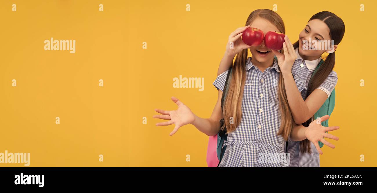 Fruit for the fruity face. Happy friends have fun with apples. Fruit ...