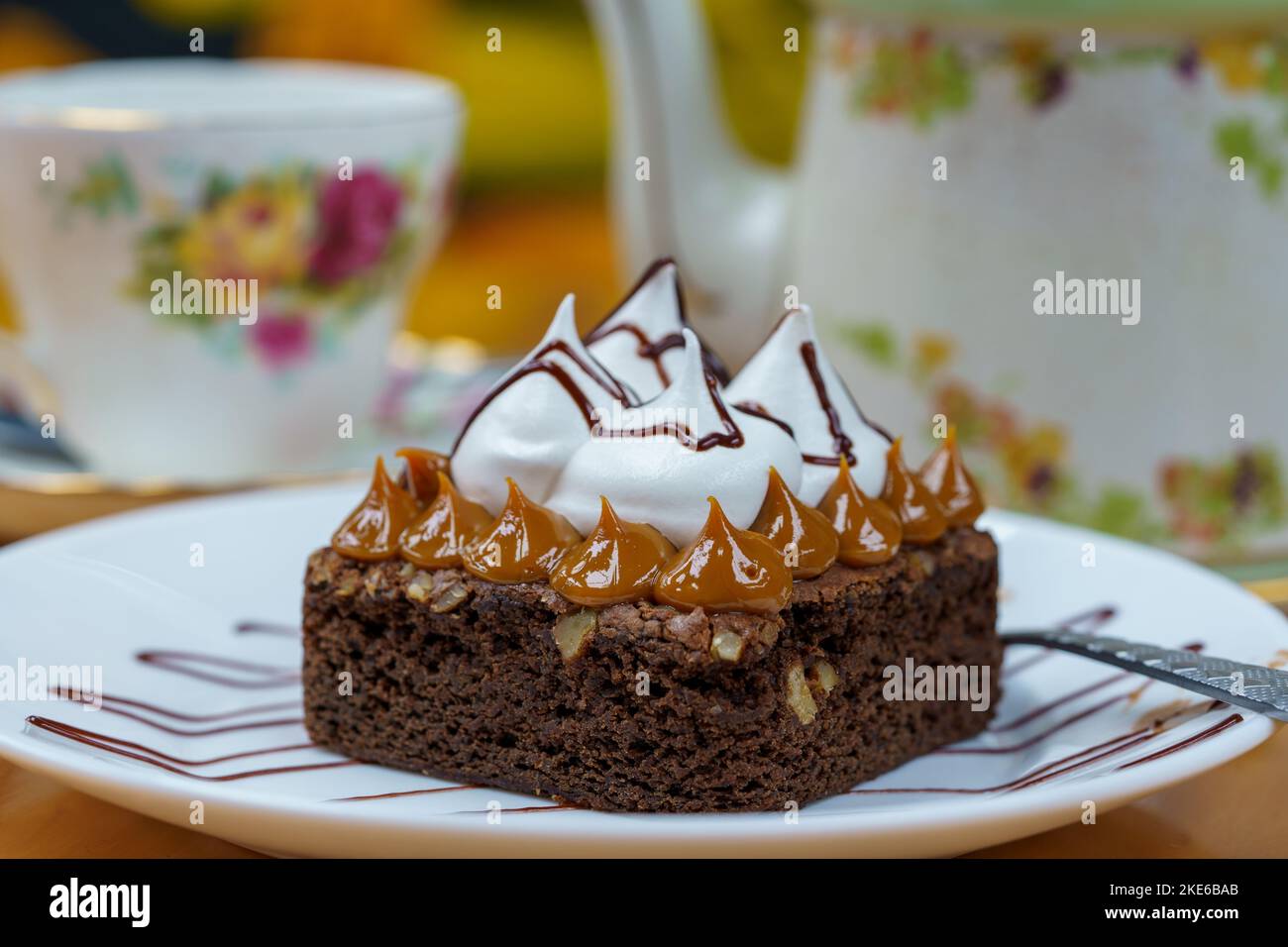 A closeup of a portion of delicious brownie with manjar and meringue on ...