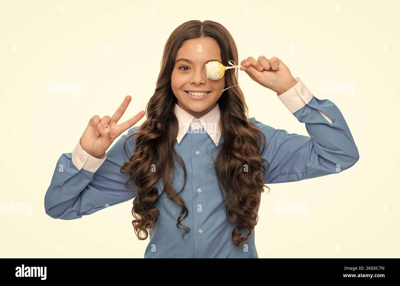 peace. cheerful child with chocolate. kid with long curly hair hold ...