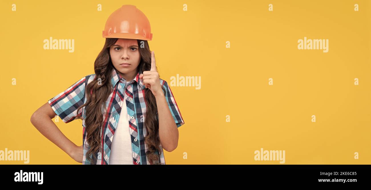 strict teen girl with curly hair in construction helmet, expert. Child ...