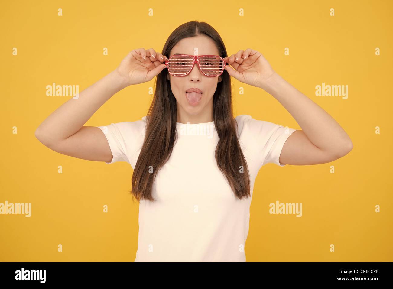 Surprised woman, shocking girl wearing funny glasses on isolated yellow ...