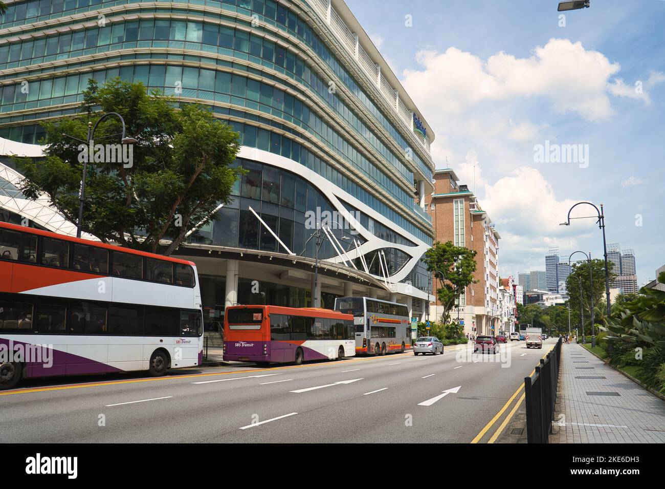 Buses stopping at a bus stop in front of Plaza Singapura, before this ...