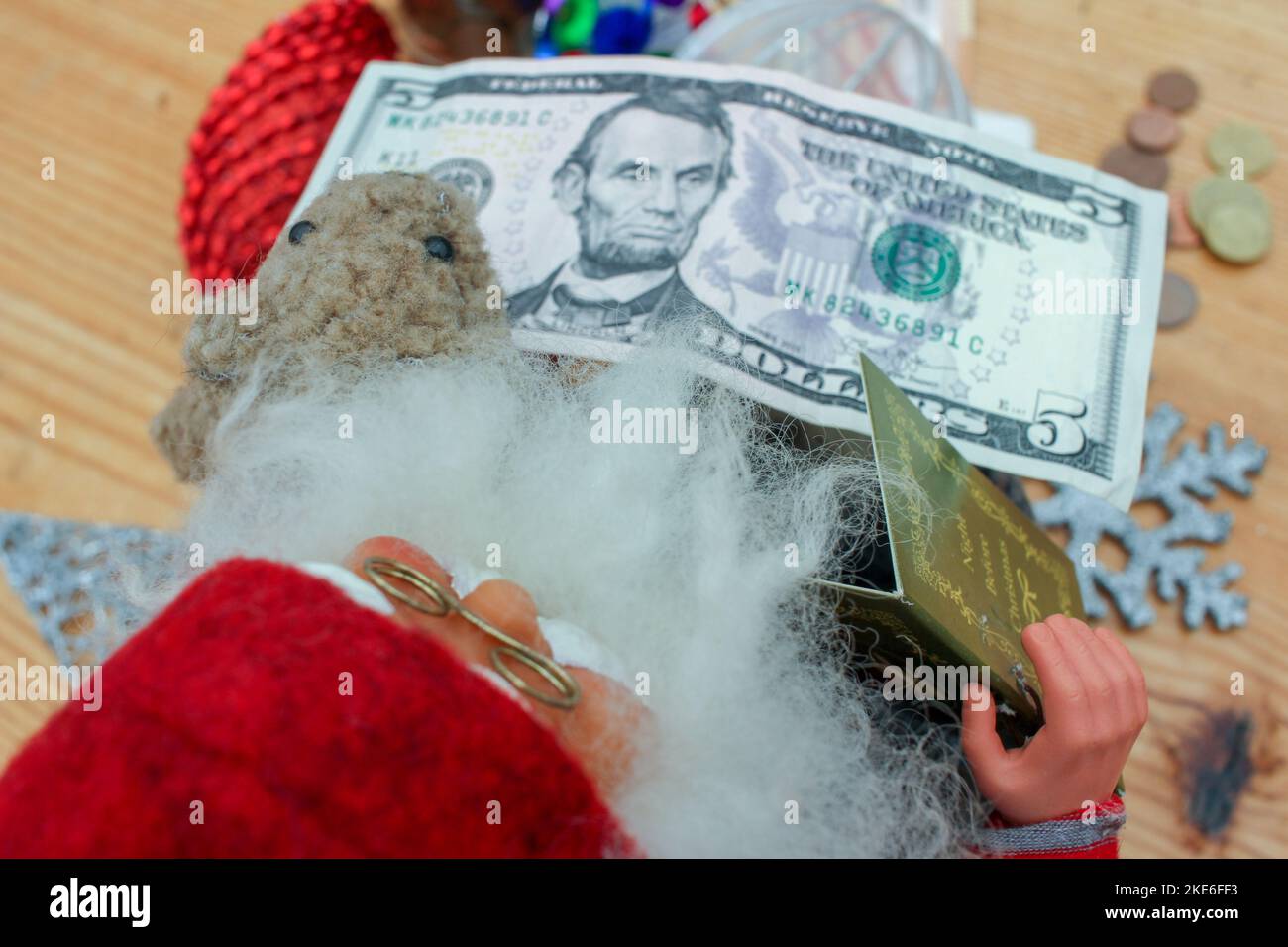 Santa with dollar notes and coins Stock Photo - Alamy