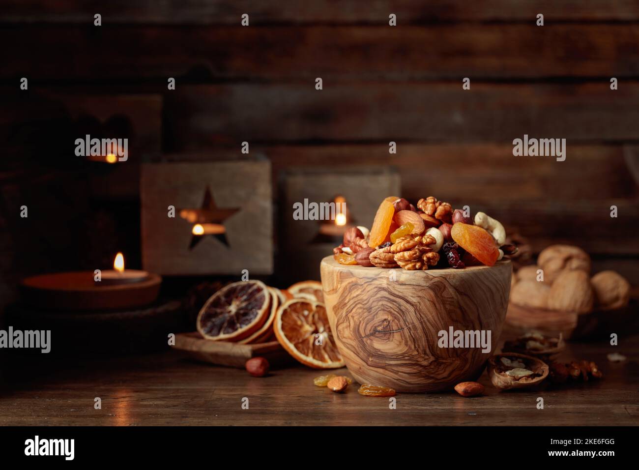 Dried fruits and assorted nuts on an old wooden table. Christmas still ...