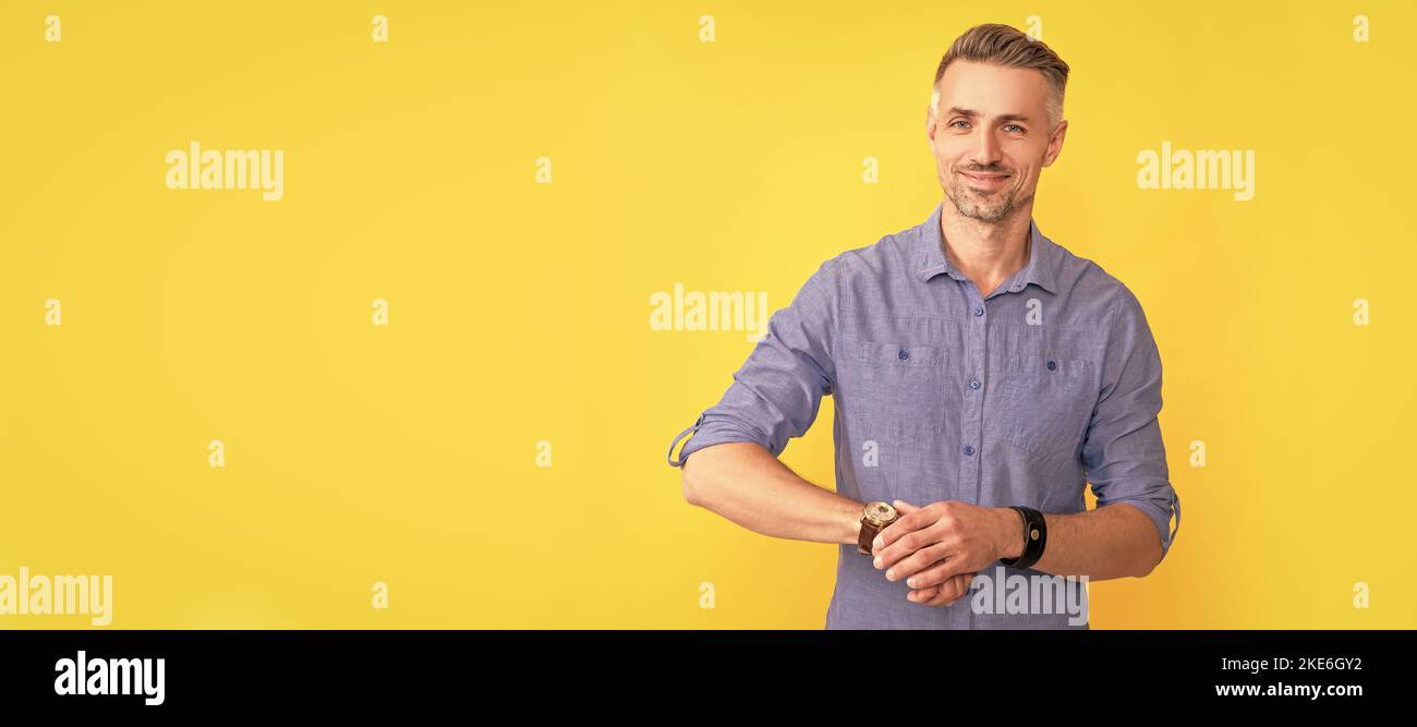 smiling man checking time. guy with hand watch. man showing wristwatch ...