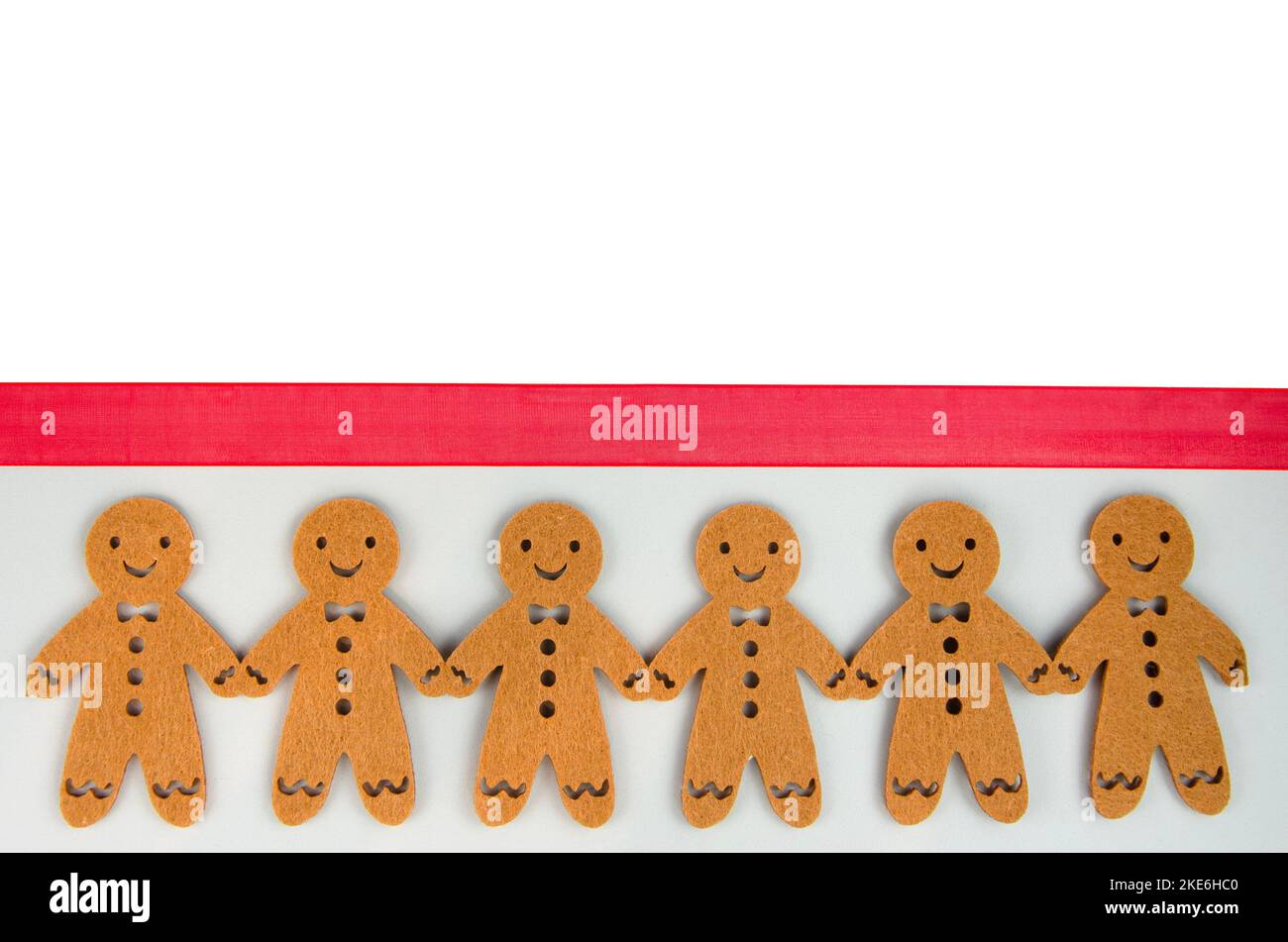 Gingerbread men in a line, red ribbon Stock Photo - Alamy