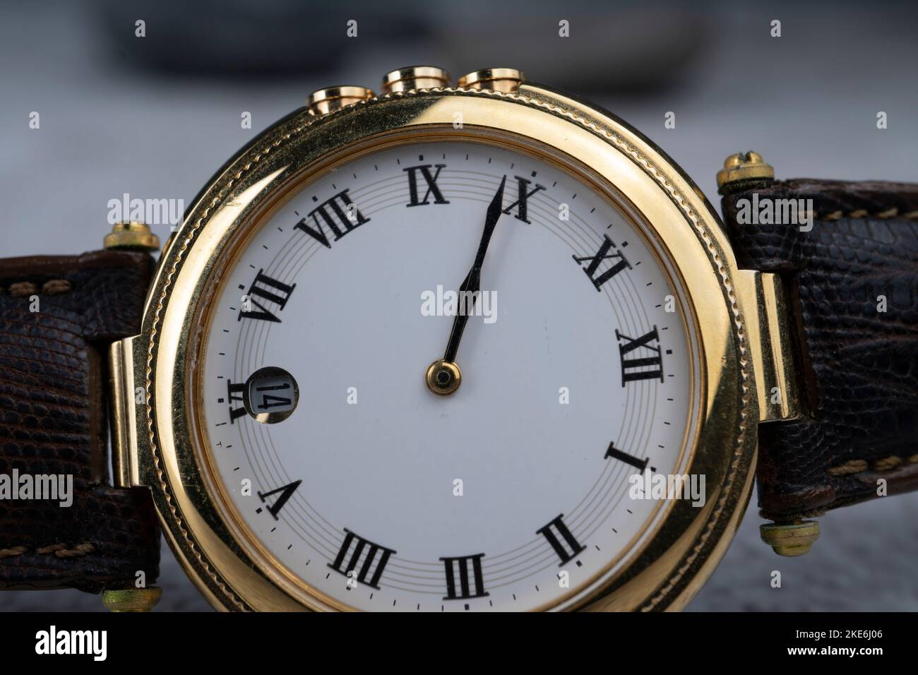 A closeup shot of a well-worn classic watch with a vintage clock face ...