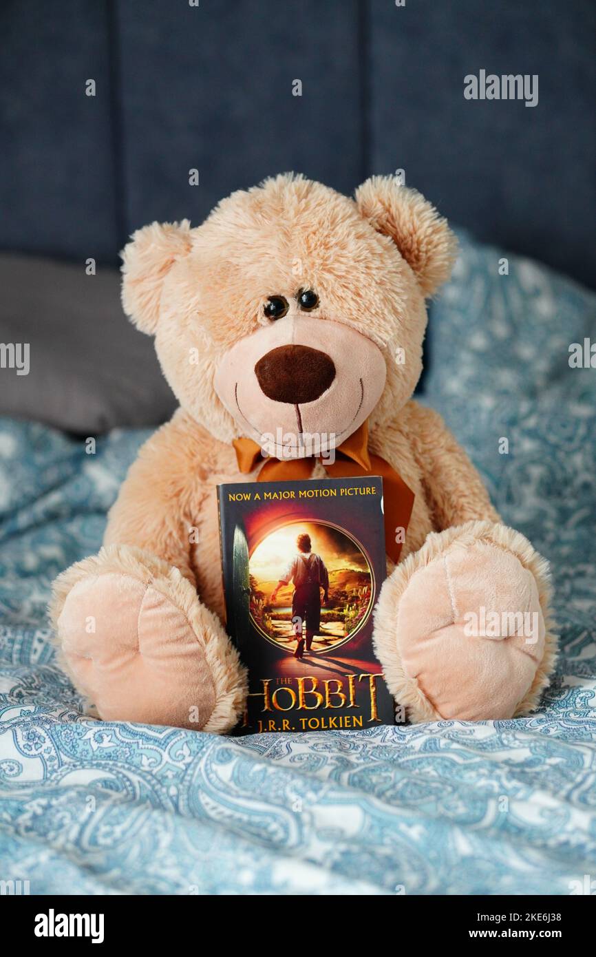 A vertical shot A J. R. R. Tolkien The Hobbit novel being held by a ...