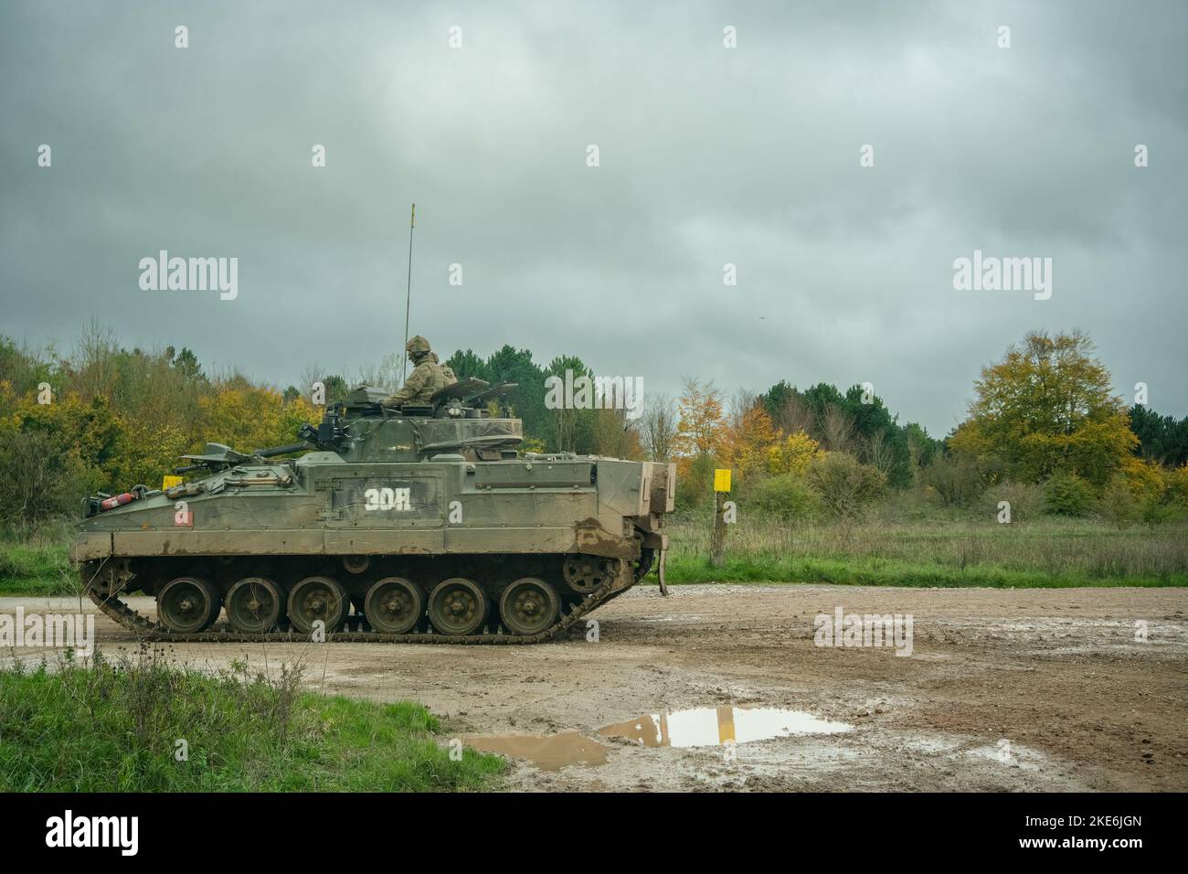 British army Warrior FV510 Fighting Vehicle crossing a sign posted road ...