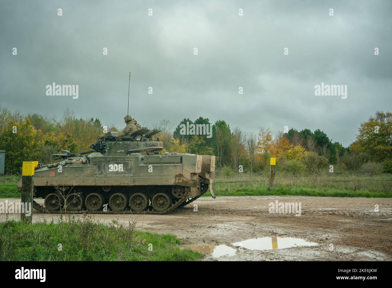 British army Warrior FV510 Fighting Vehicle crossing a sign posted road ...
