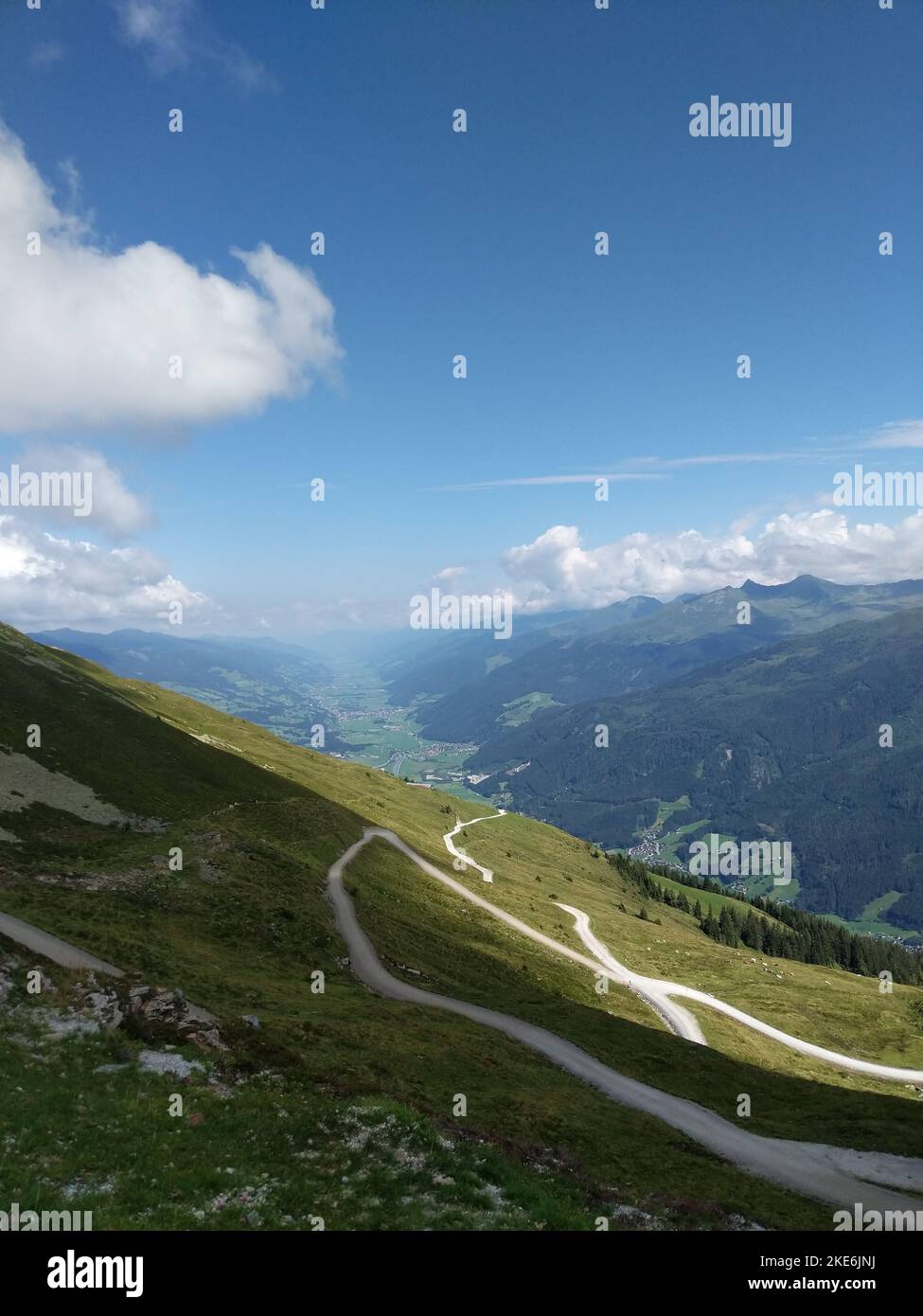 A Mountainous landscape with green grass on a sunny day Stock Photo - Alamy