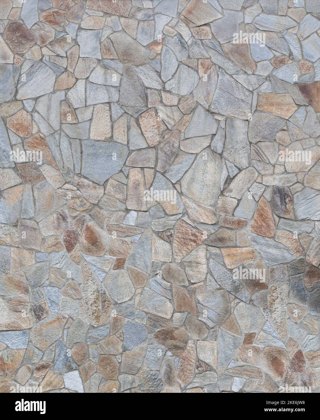 Front view of stone wall made of weathered and multi-colored stone ...